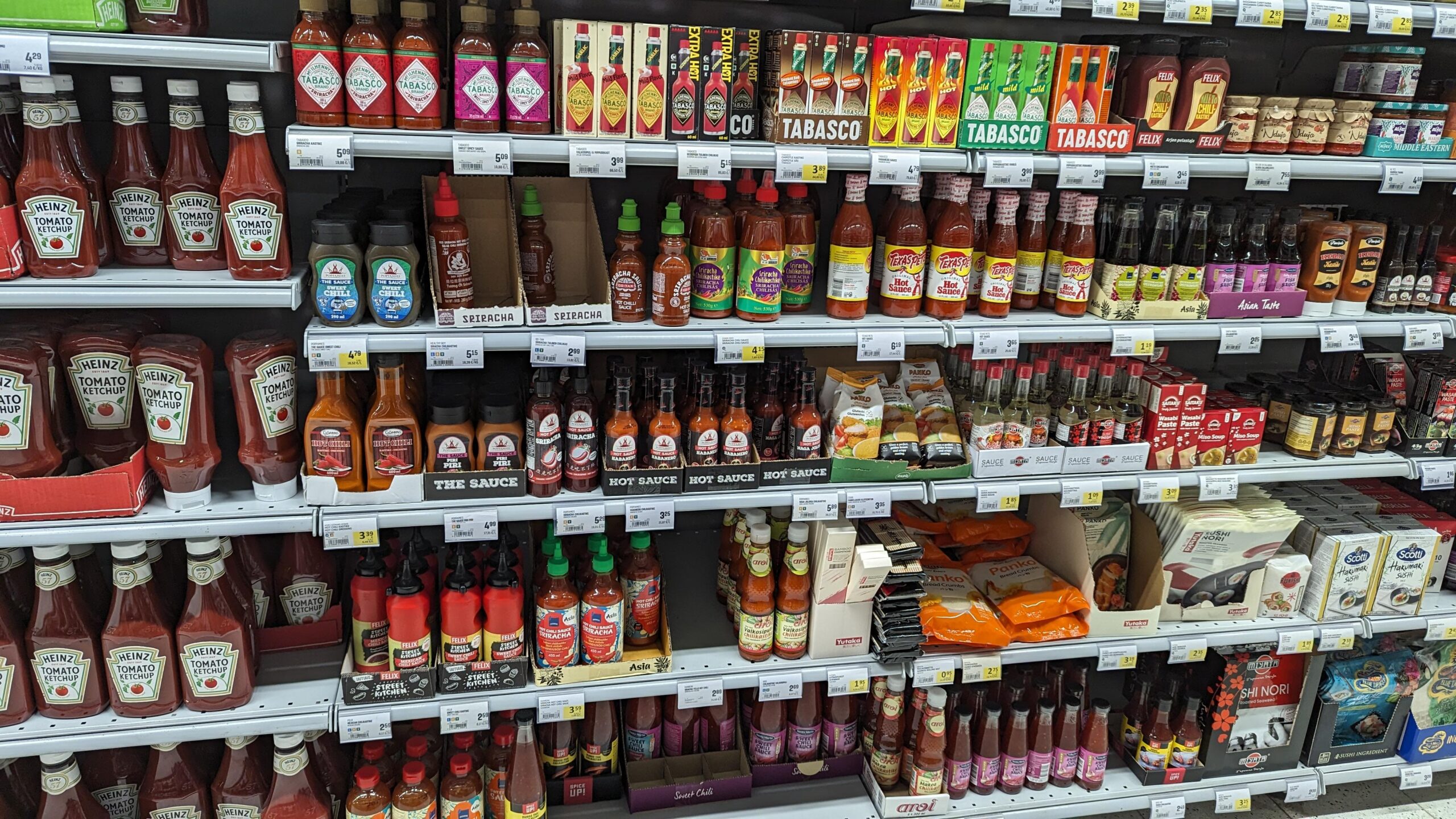 Hot sauce section in a midsized Finnish grocery store - Chili Chili